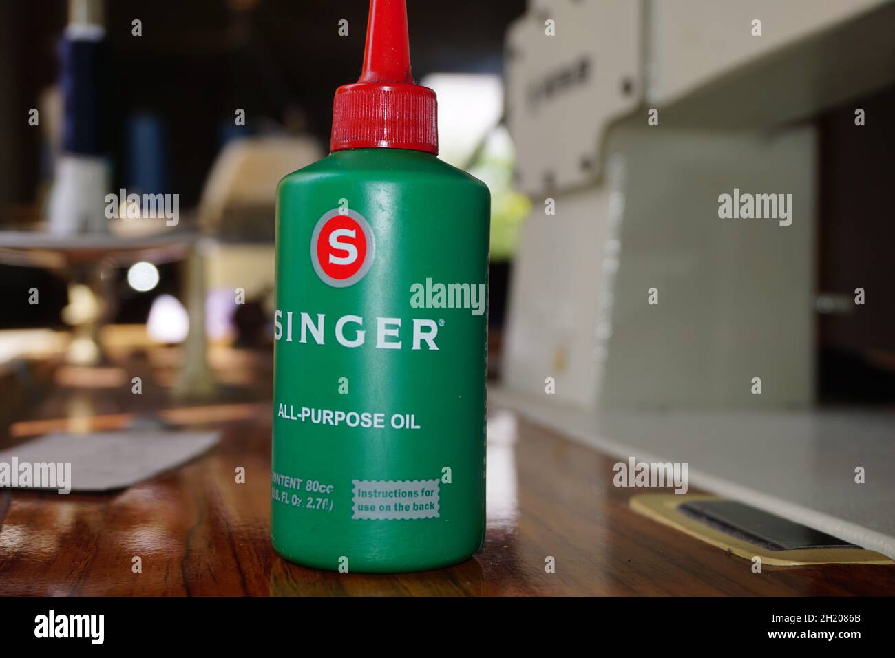 Green a bottle of lubricant for sewing machine Stock Photo - Alamy
