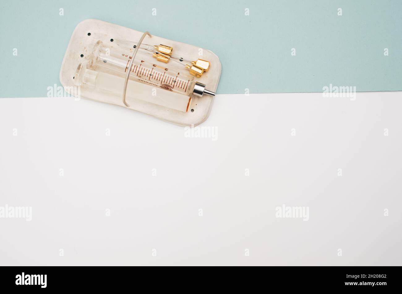 isolated sterilized glass injection syringe in a box on a blue Stock ...