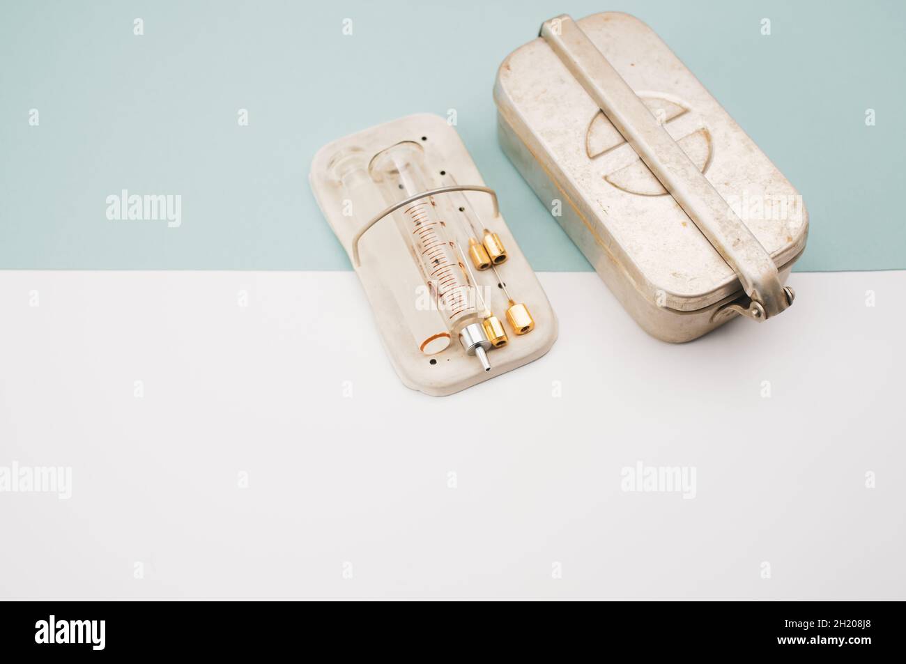 isolated sterilized glass injection syringe in a box on a blue Stock ...