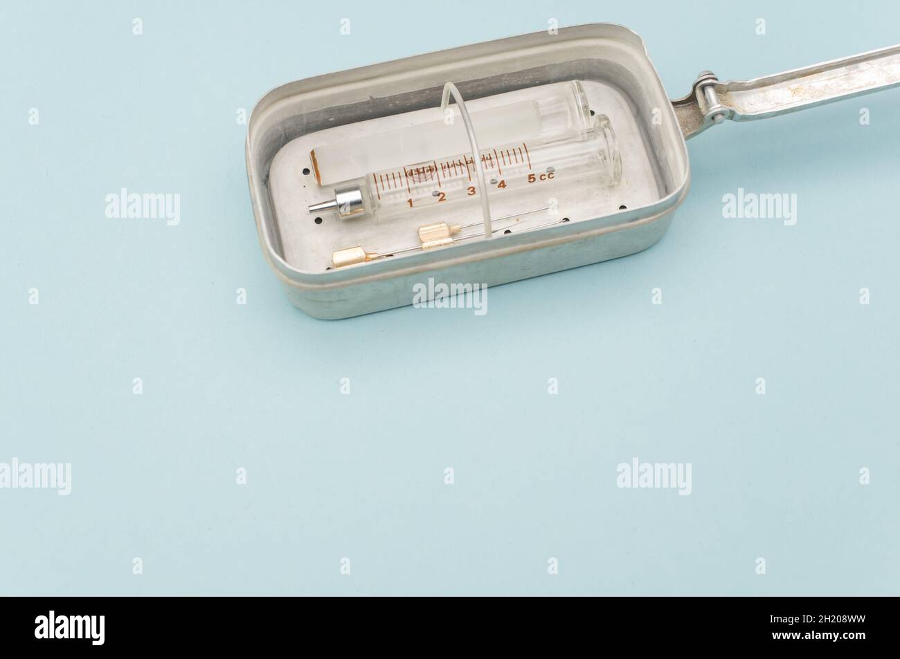 isolated sterilized glass injection syringe in a box on a blue Stock ...