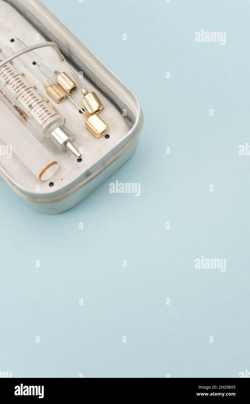 isolated sterilized glass injection syringe in a box on a blue Stock ...