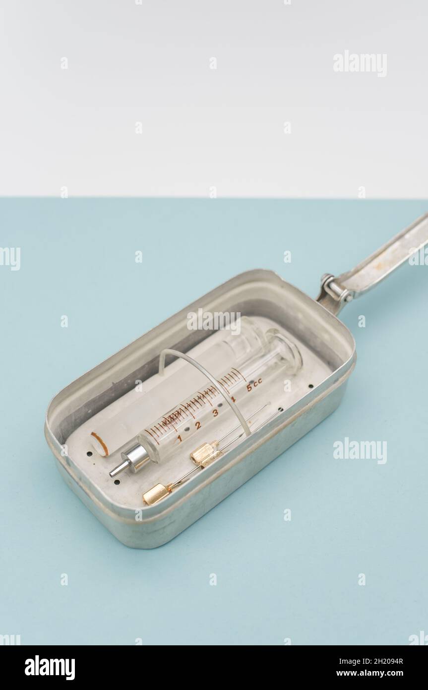 isolated sterilized glass injection syringe in a box on a blue Stock ...