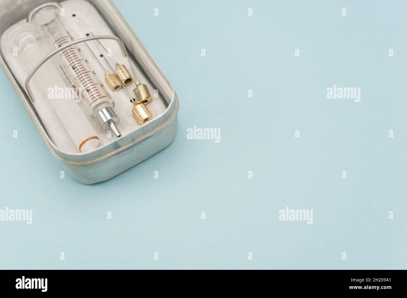isolated sterilized glass injection syringe in a box on a blue Stock ...