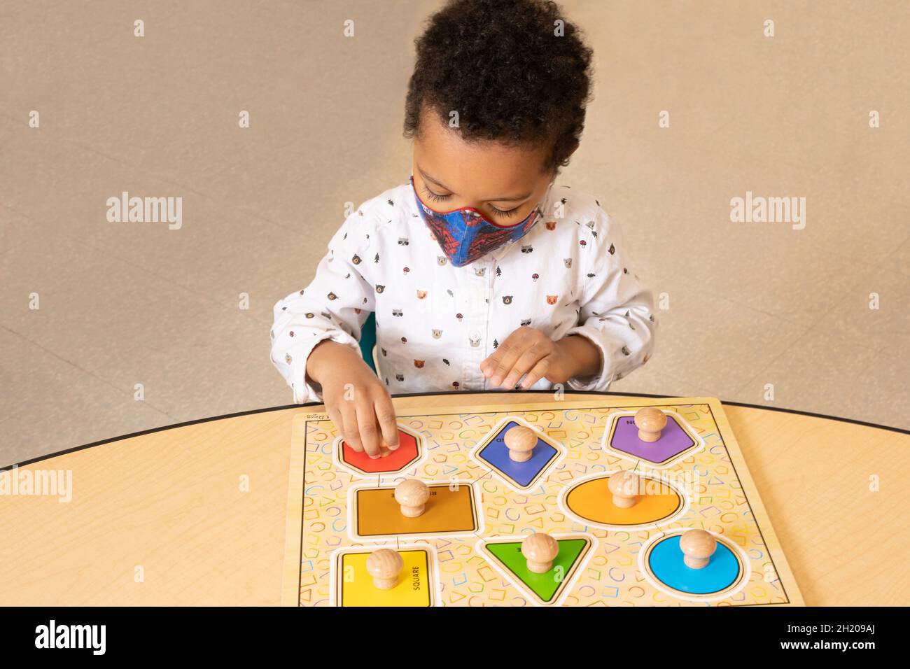 Education Preschool 3-4 year olds boy playing with geometric shapes ...