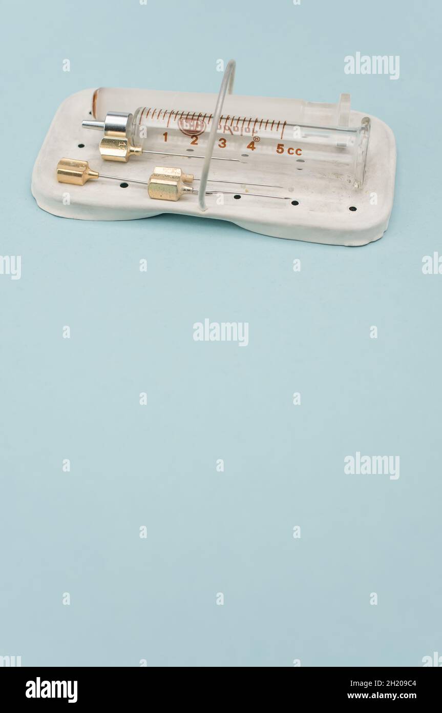 isolated sterilized glass injection syringe in a box on a blue Stock ...