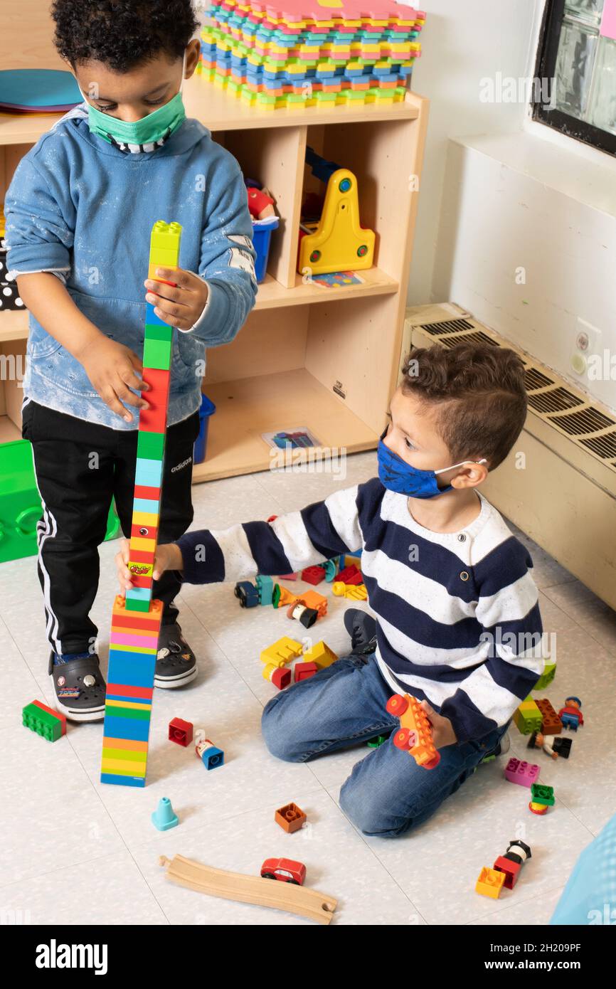 Education Preschool 3-4 year olds two boys building with colorful ...