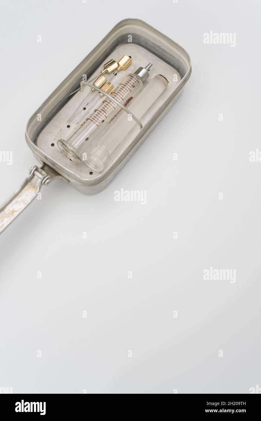 isolated sterilized glass injection syringe in a box on a white ...