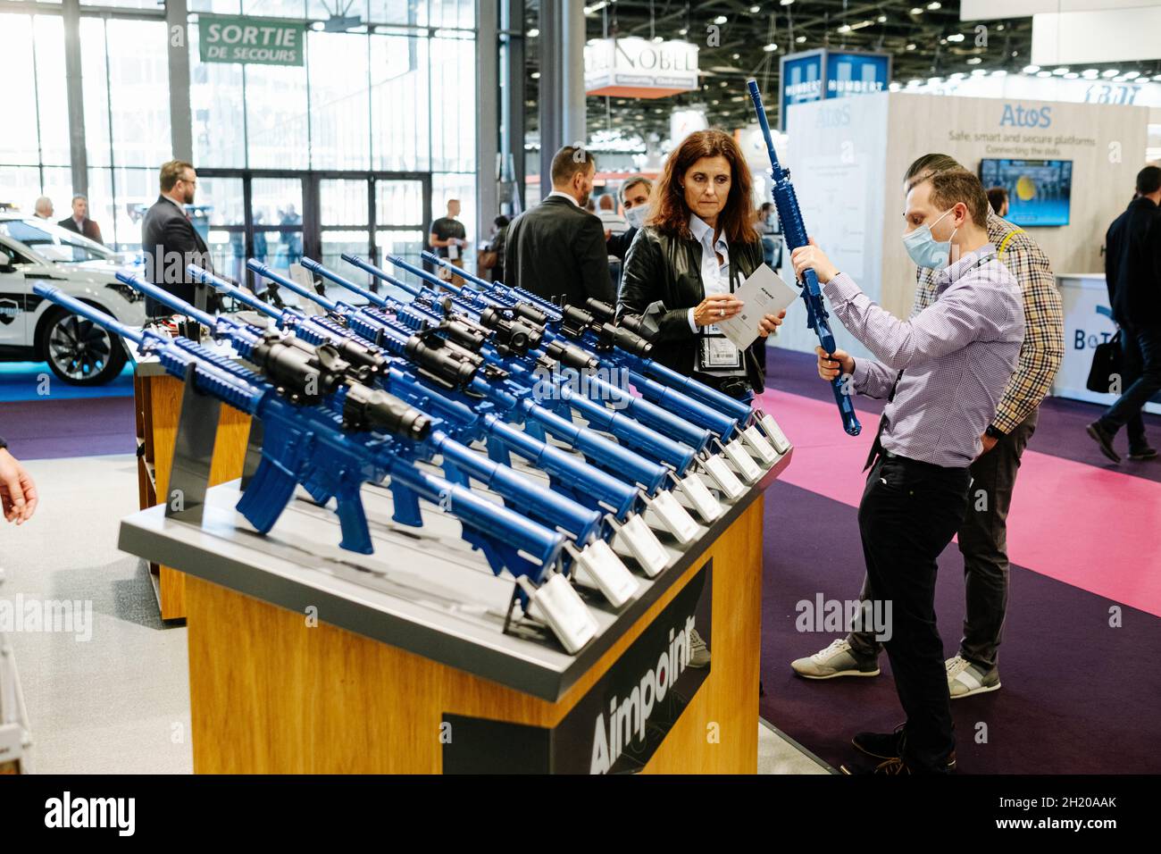 A man tries a riffle at the Milipole exposition. The Milipol exhibition ...