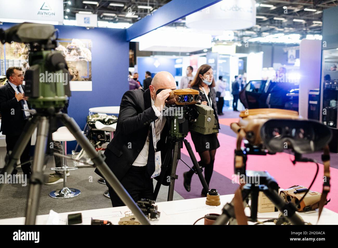 A man tries binoculars at the Milipol exposition. The Milipol ...