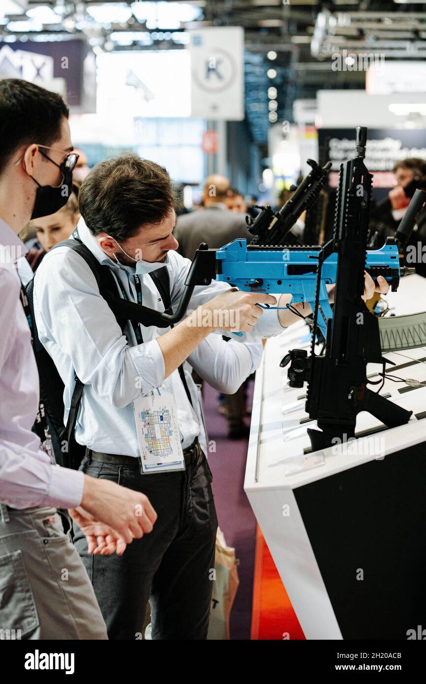 A man tries a riffle at the Milipol exposition. The Milipol exhibition ...