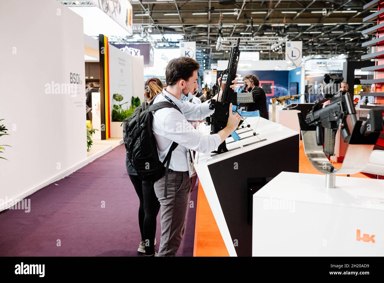 A man tries a riffle at the Milipol exposition. The Milipol exhibition ...