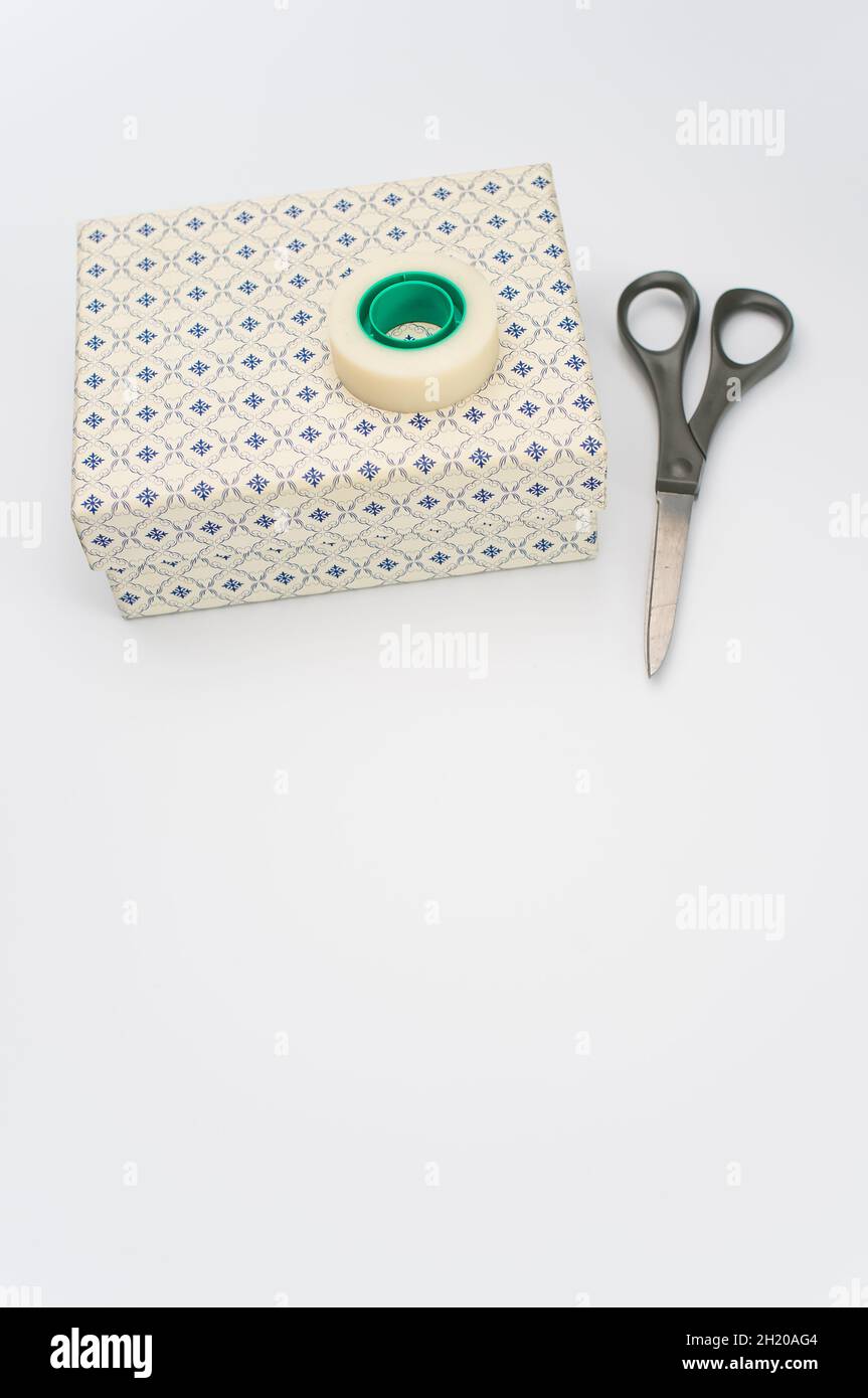 decorated paperboard box with lid on top and stationery on a white ...