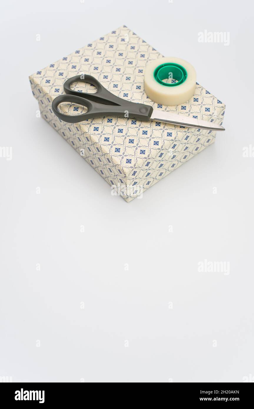 decorated paperboard box with lid on top and stationery on a white ...