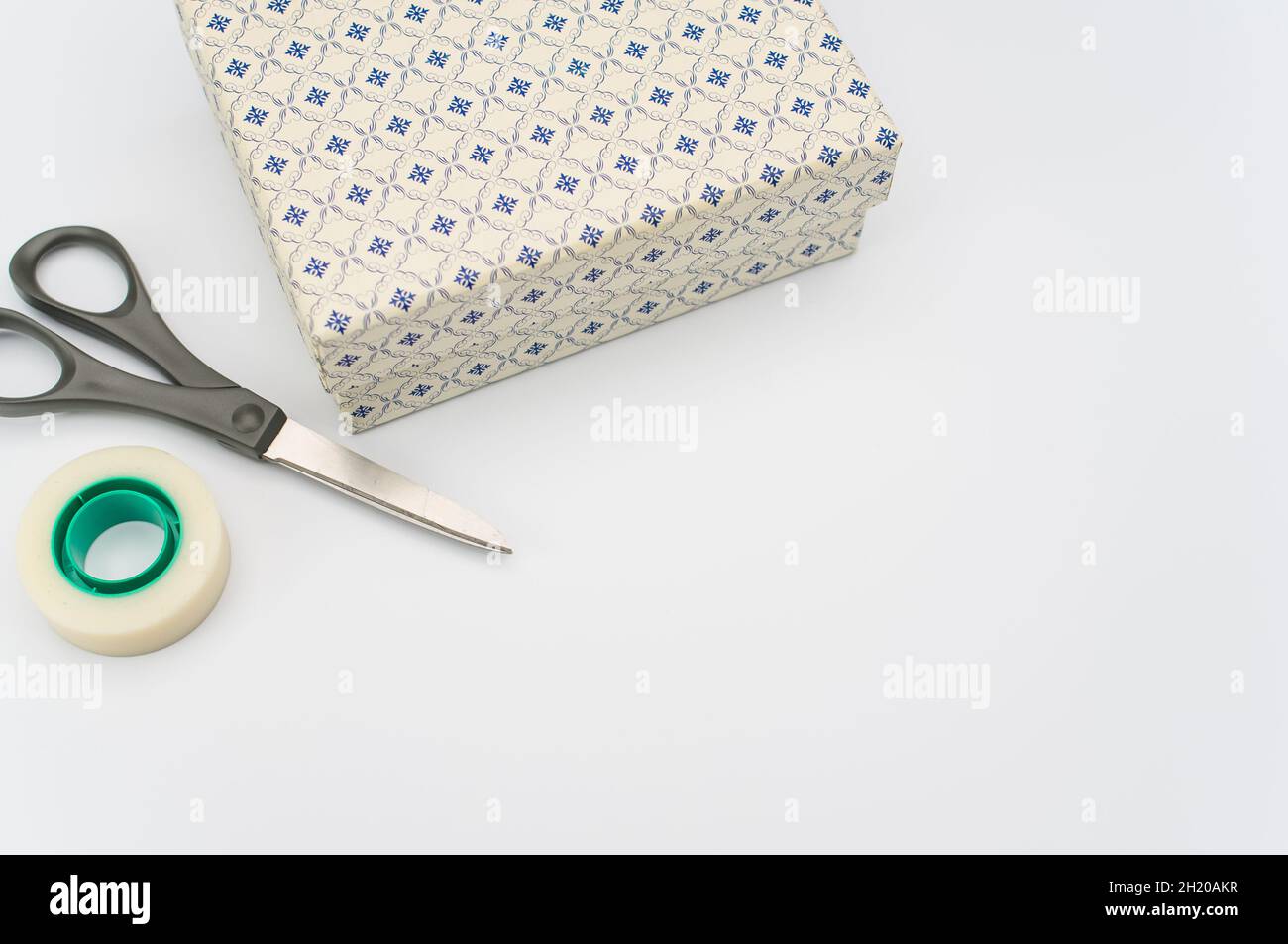 decorated paperboard box with lid on top and stationery on a white ...