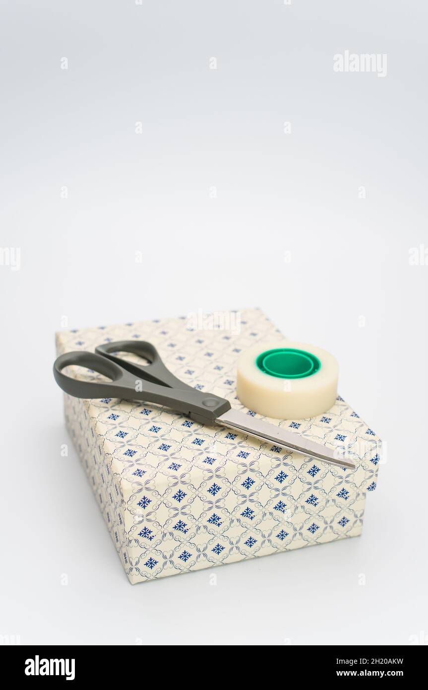 decorated paperboard box with lid on top and stationery on a white ...