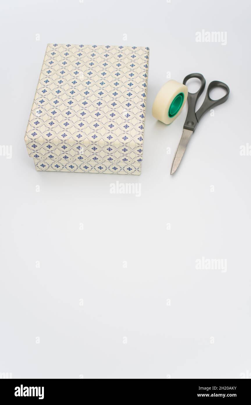 decorated paperboard box with lid on top and stationery on a white ...