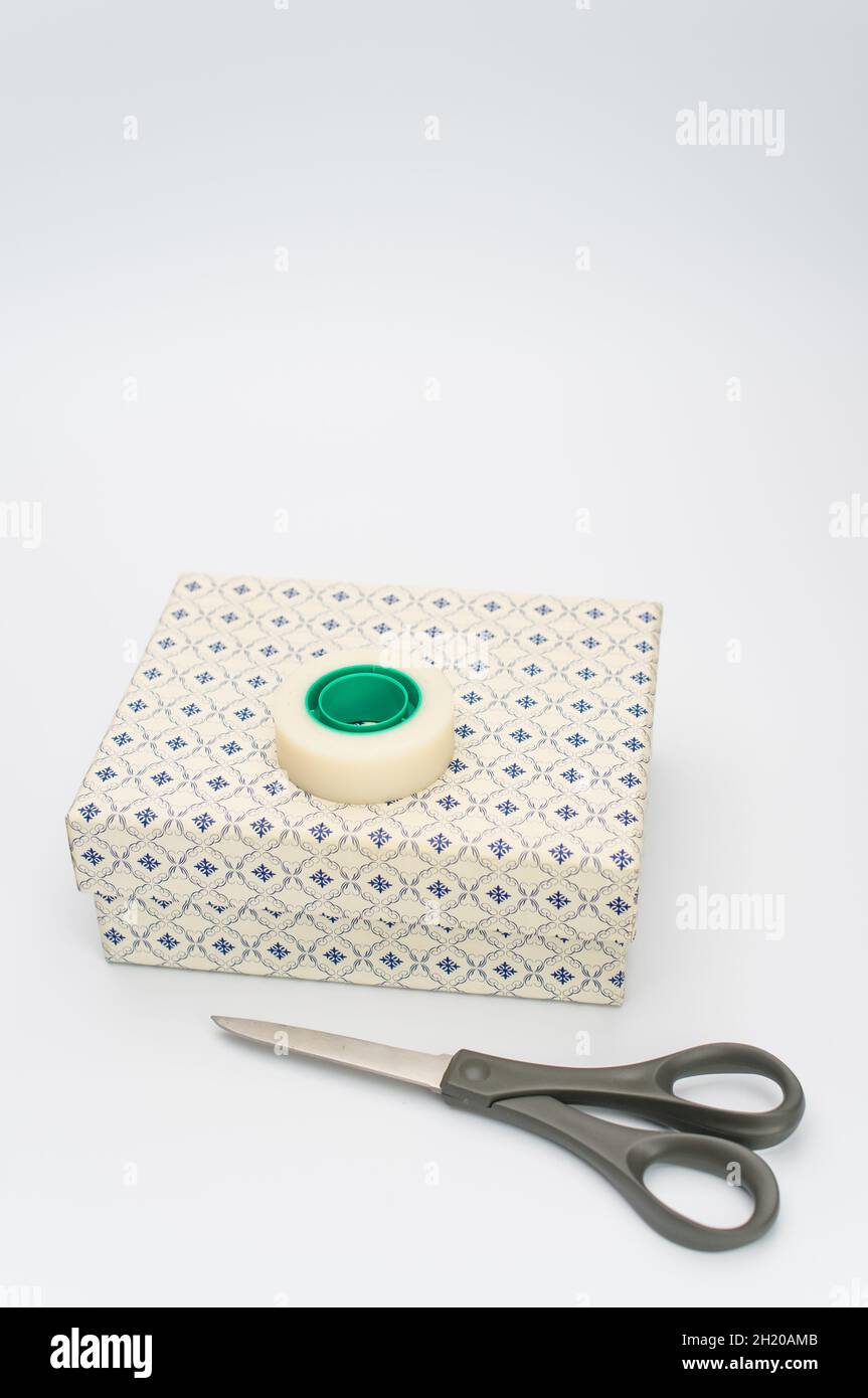 decorated paperboard box with lid on top and stationery on a white ...