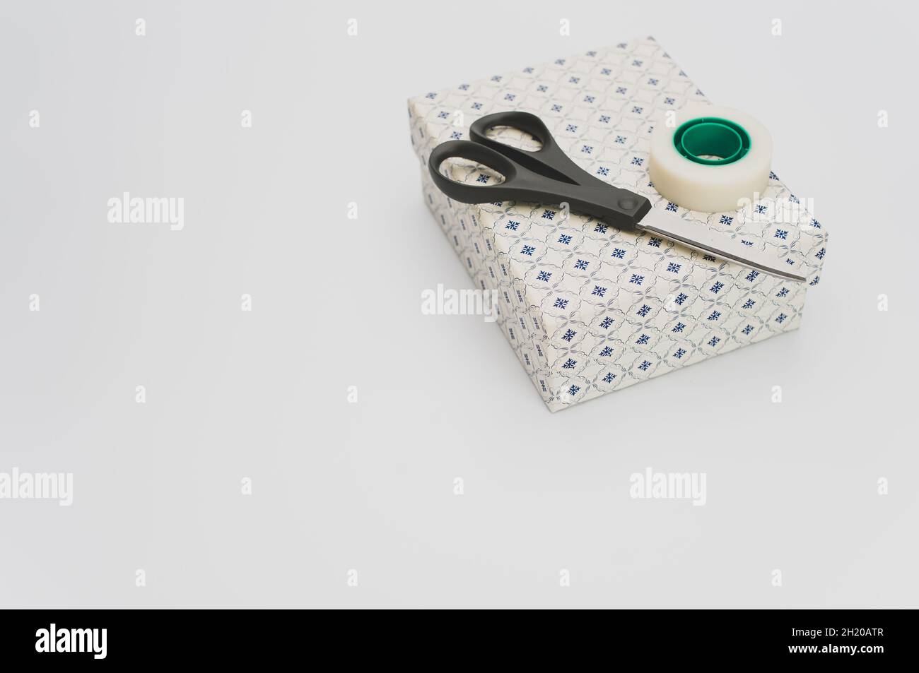 decorated paperboard box with lid on top and stationery on a white ...