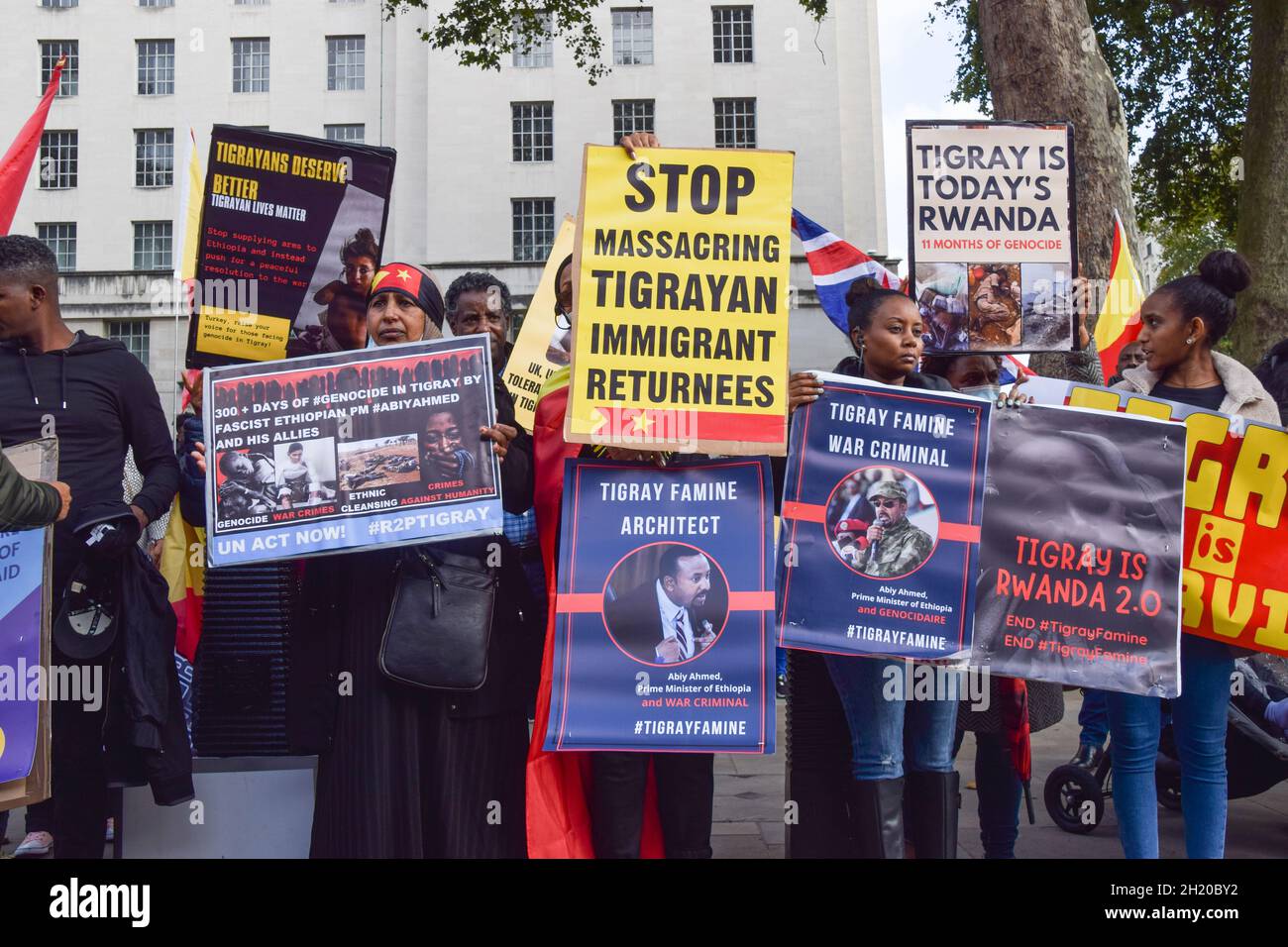 London, UK. 19th Oct, 2021. Protesters hold placards calling for an end ...