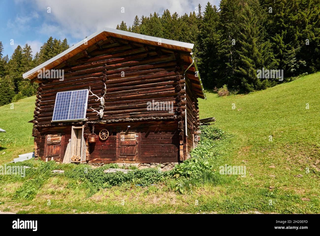 1 An Old Wooden Stable Equipped With Solar Cells And Deer Antlers ...