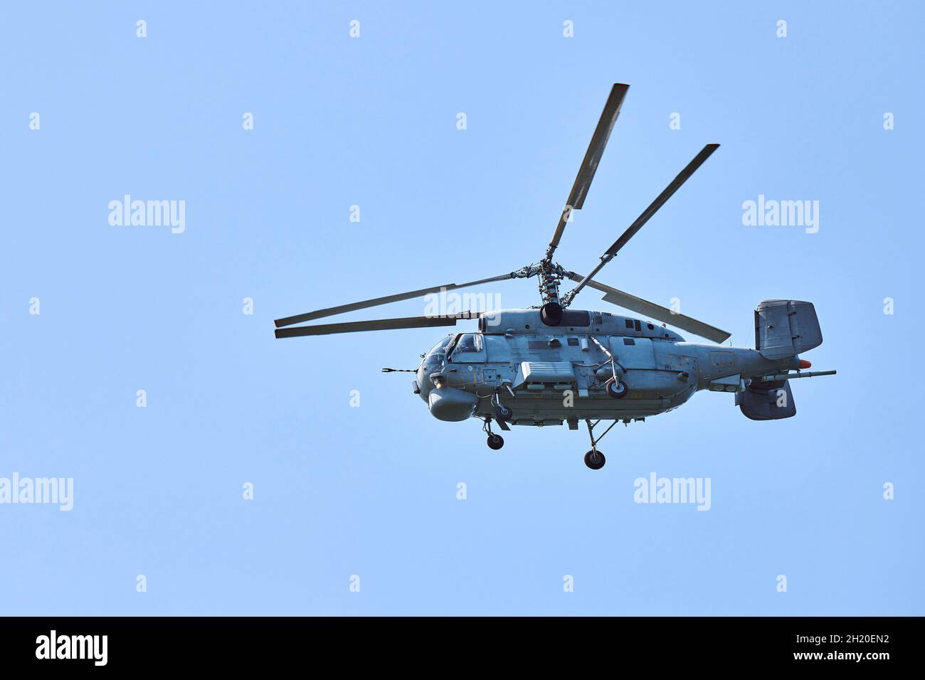 Navy helicopter flying against bright blue sky background, copy space ...