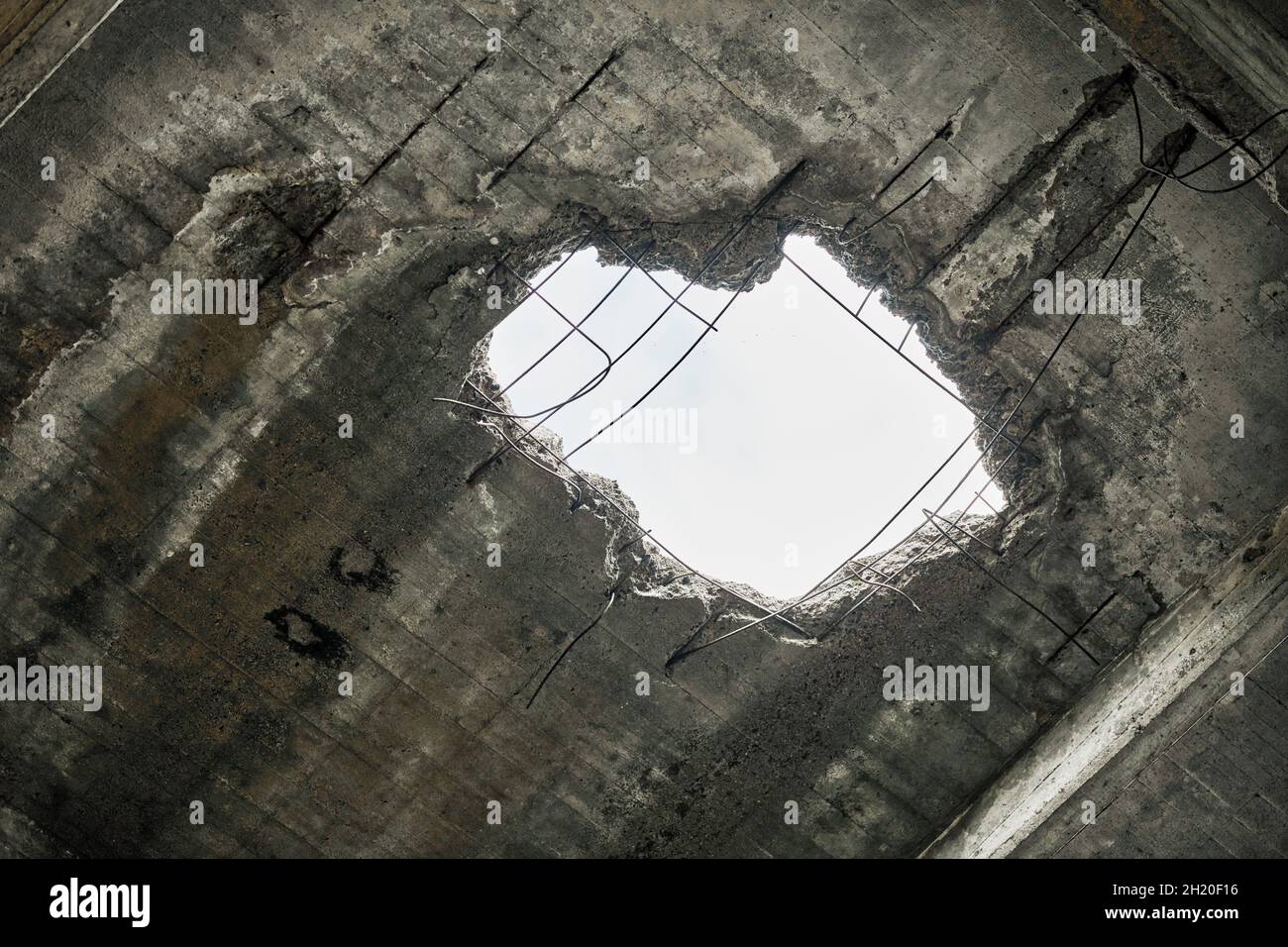 Vintage abandoned damaged house roof with hole in ceiling overlooking ...