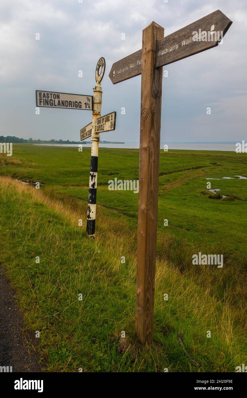 Signposts on Easton Marsh in Cumbria on the Hadrians Path route, a salt ...