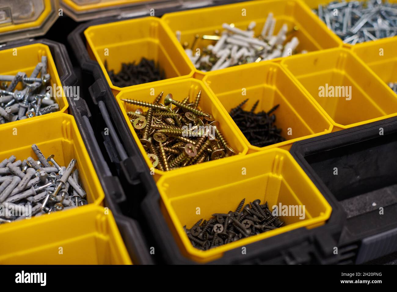 Yellow case with small construction objects. Many storage compartments ...