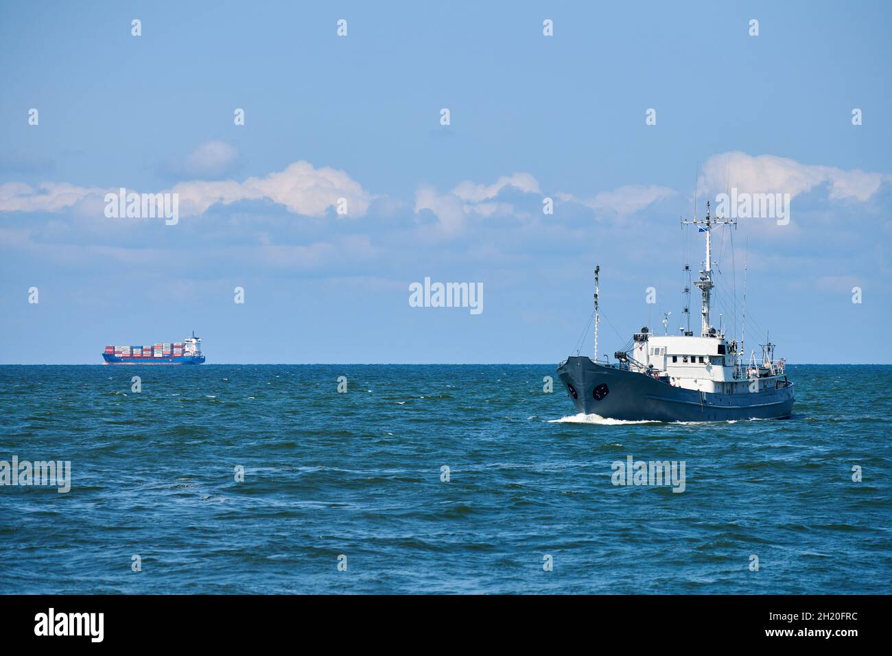Survey vessel, research vessel patrol boat sailing in bright blue ...