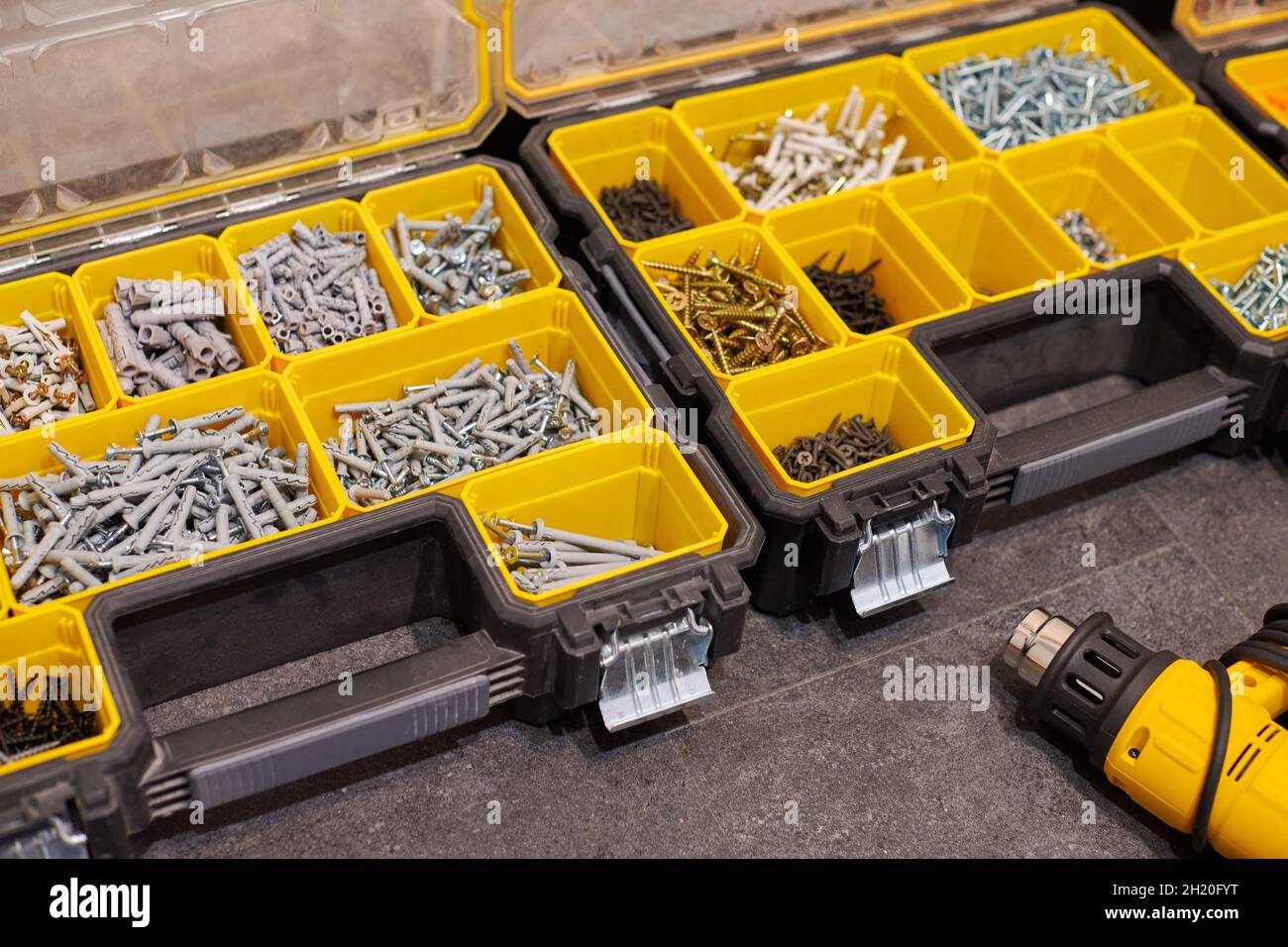 Two storage boxes on floor with small construction objects. Many ...