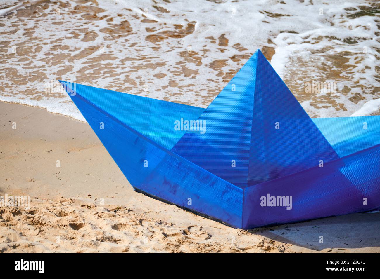 Origami blue paper boat on sandy beach for concept design, beautiful ...