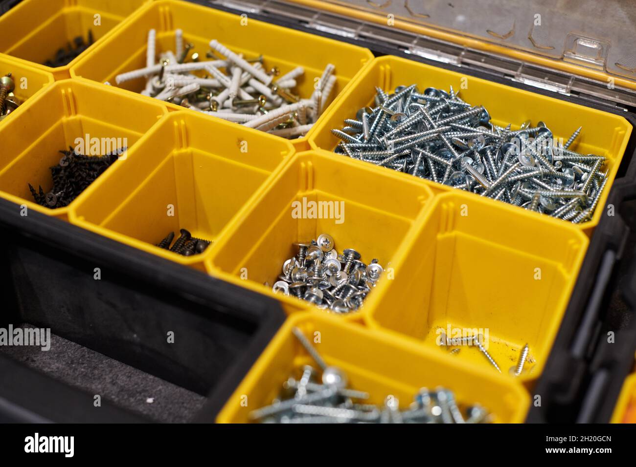 Yellow case with small construction objects. Many storage compartments ...
