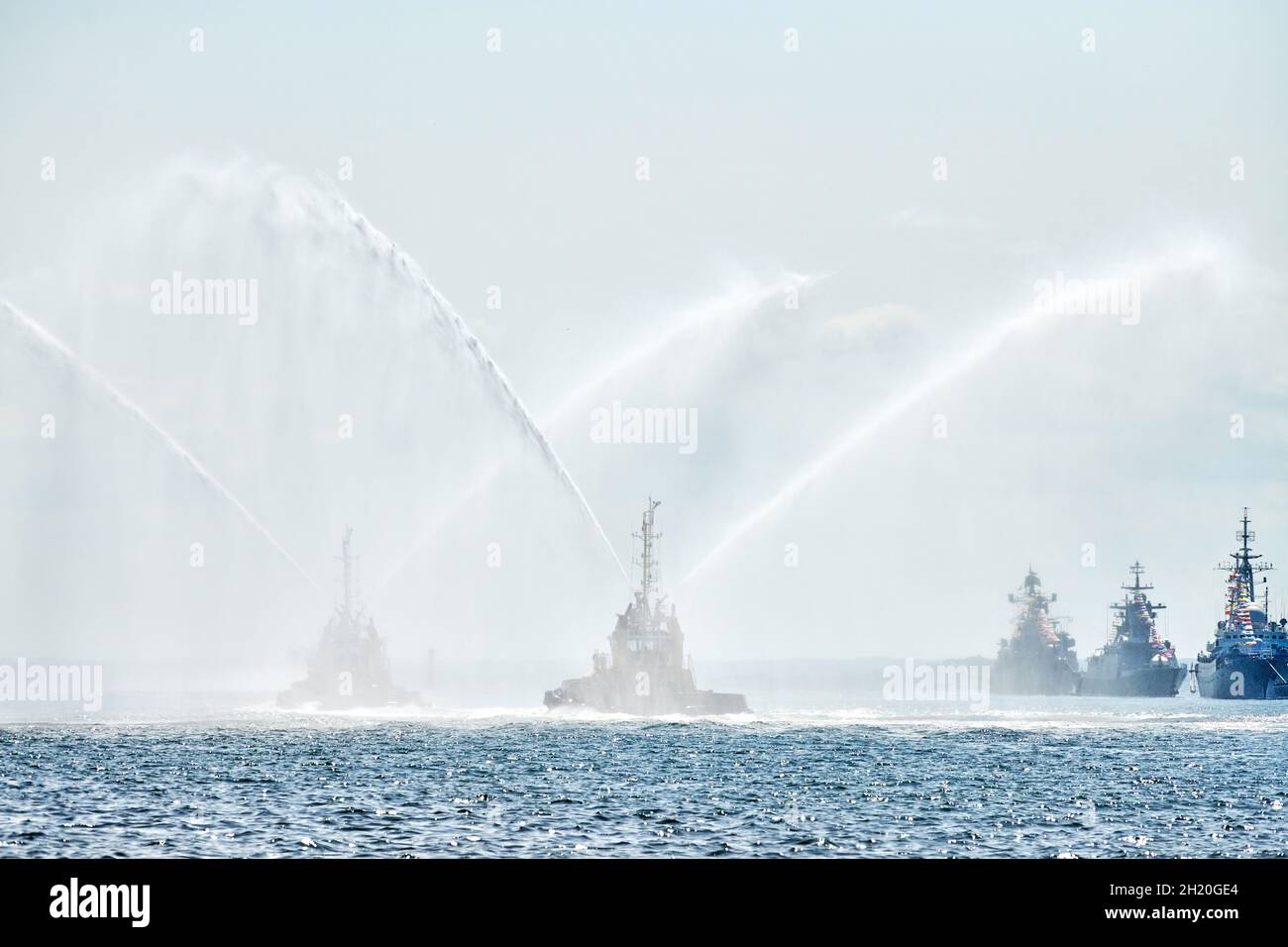 Floating tug boats spraying jets of water, demonstrating firefighting ...