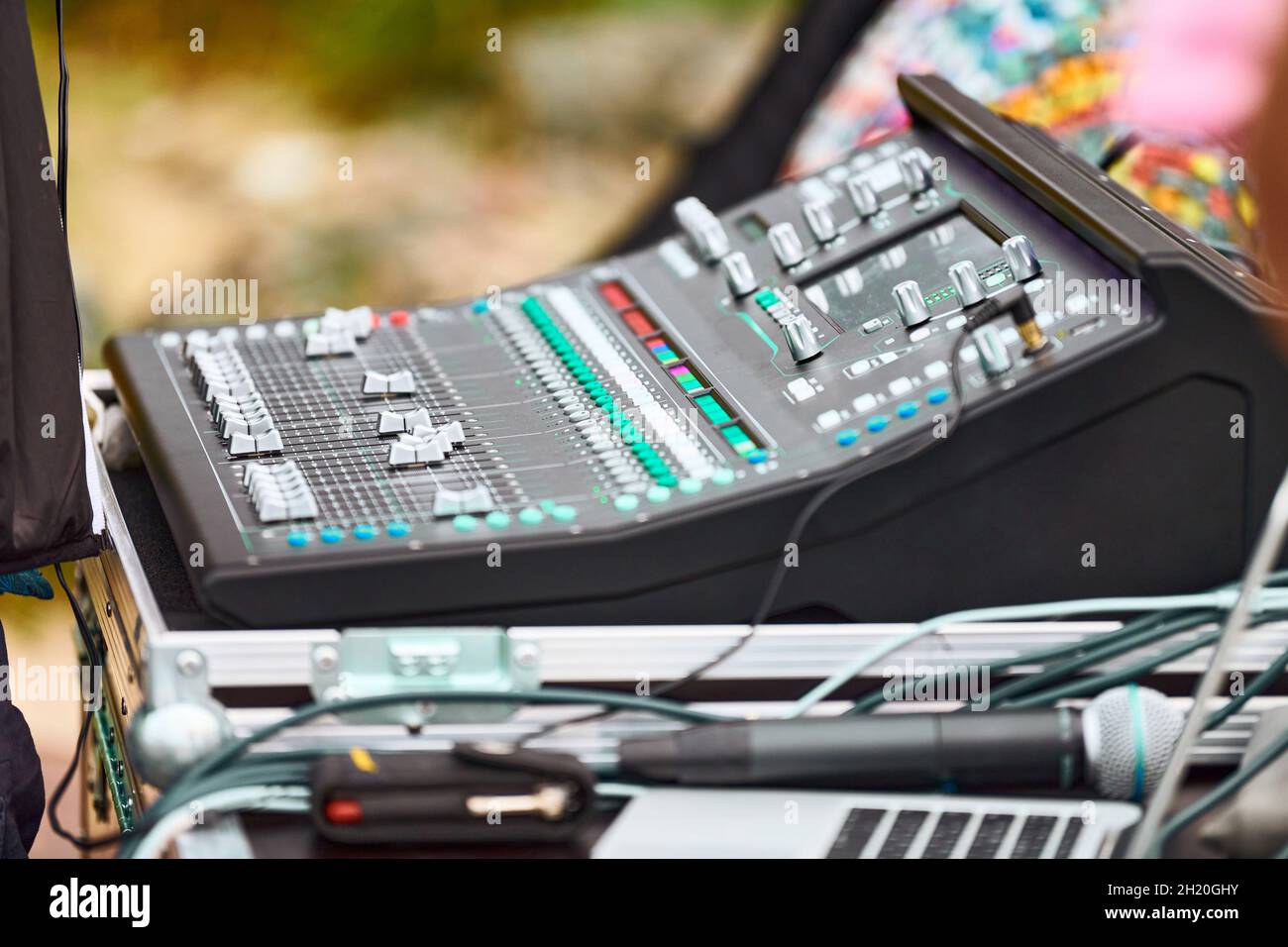 Sound engineer hand adjusting audio mixer at live concert outdoor ...