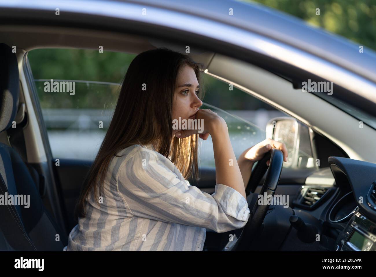 Drunk girl driving car. Unhappy tired young female in vehicle suffering ...
