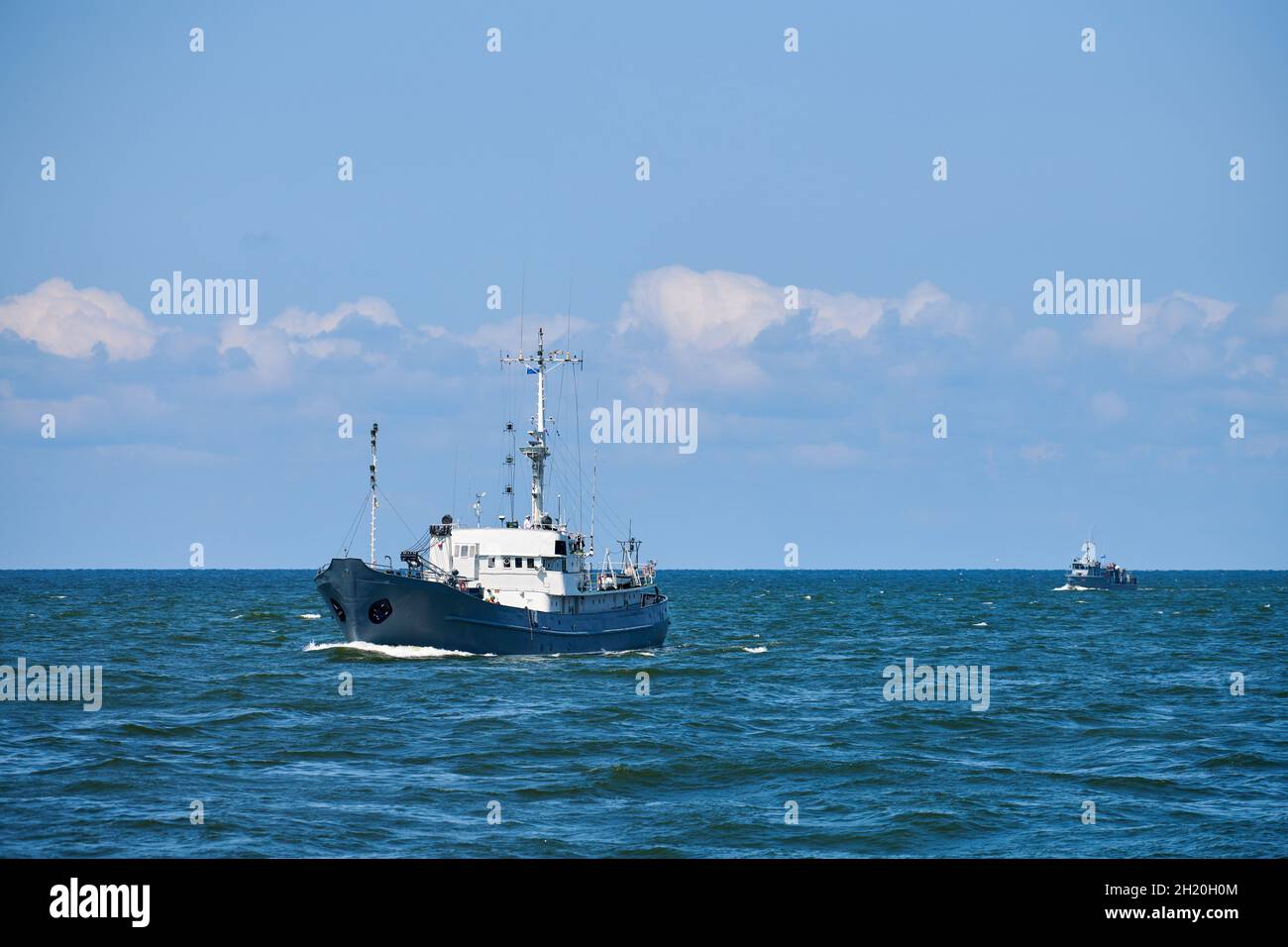 Survey vessel, research vessel patrol boat sailing in bright blue ...