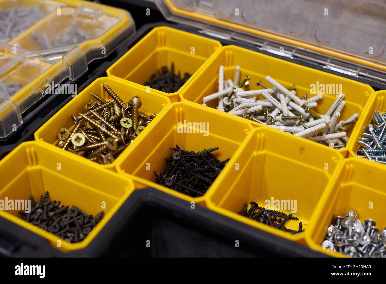 Yellow case with small construction objects. Many storage compartments ...