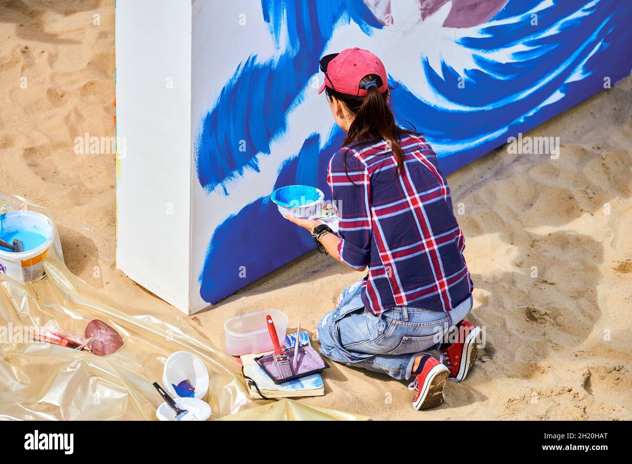 Female painter working on abstract oil painting moving paint brush ...