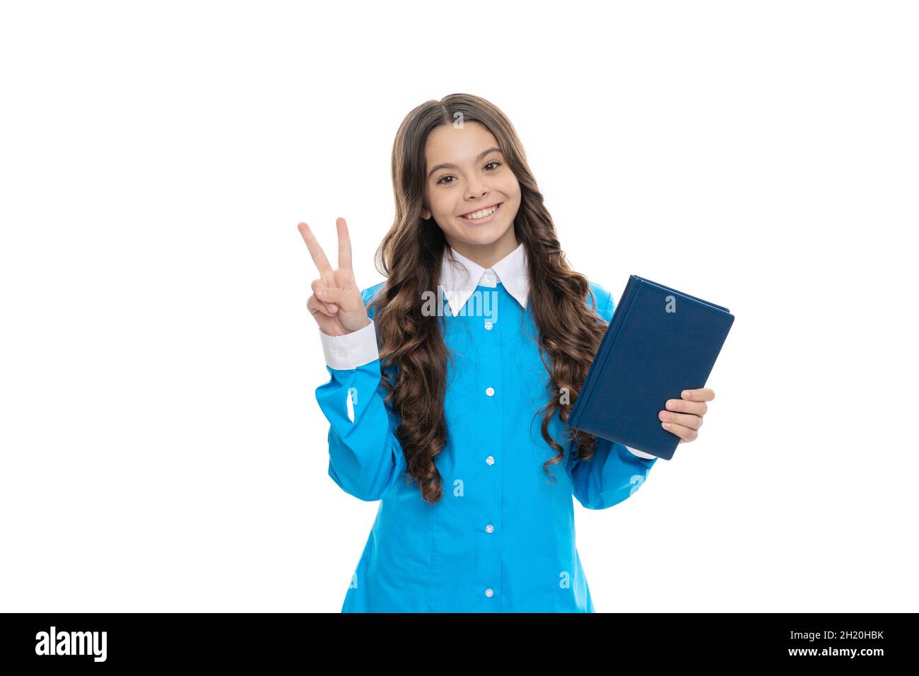 Happy child hold school book showing V hand signal isolated on white ...
