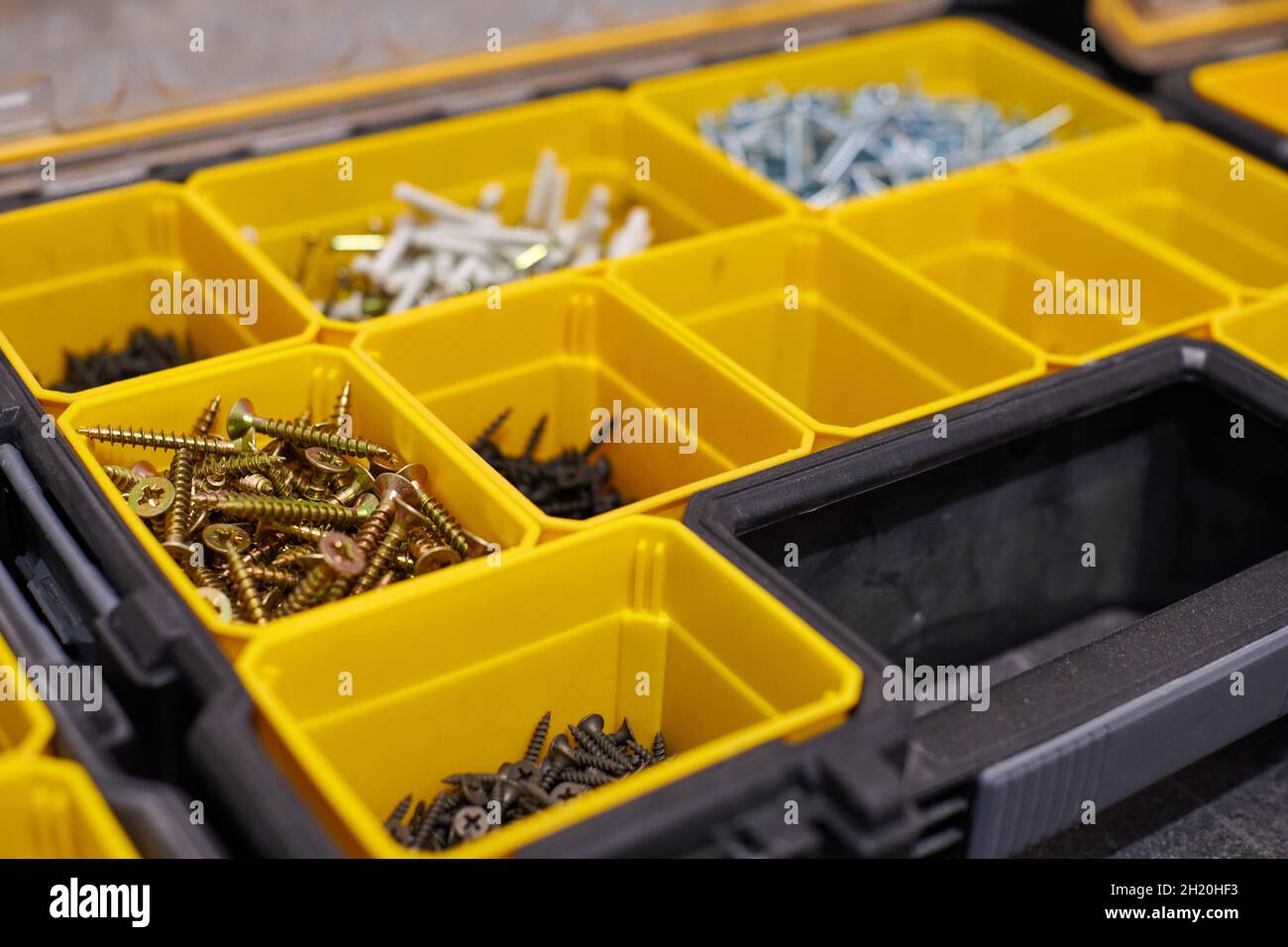 Yellow case with small construction objects. Many storage compartments ...