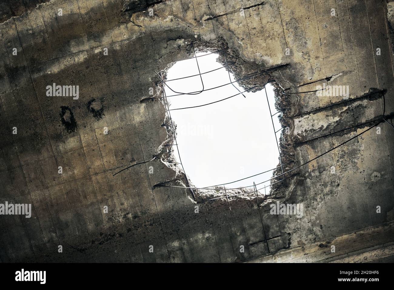 Vintage abandoned damaged house roof with hole in ceiling overlooking ...