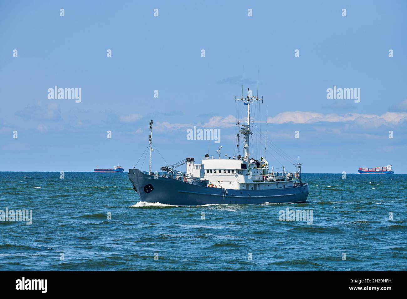 Survey vessel, research vessel patrol boat sailing in bright blue ...