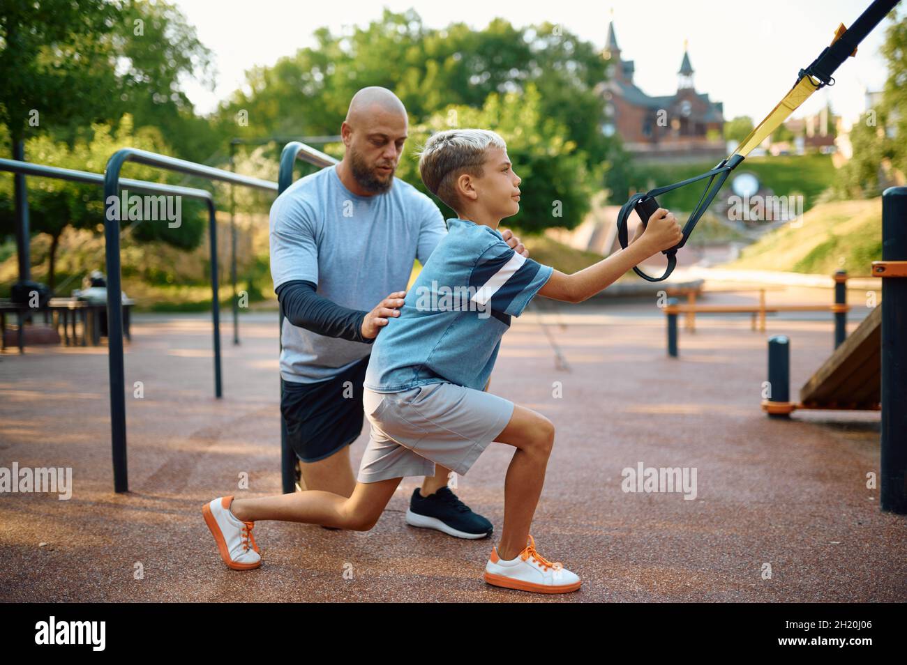 Father and son, exercise with ropes on playground Stock Photo - Alamy