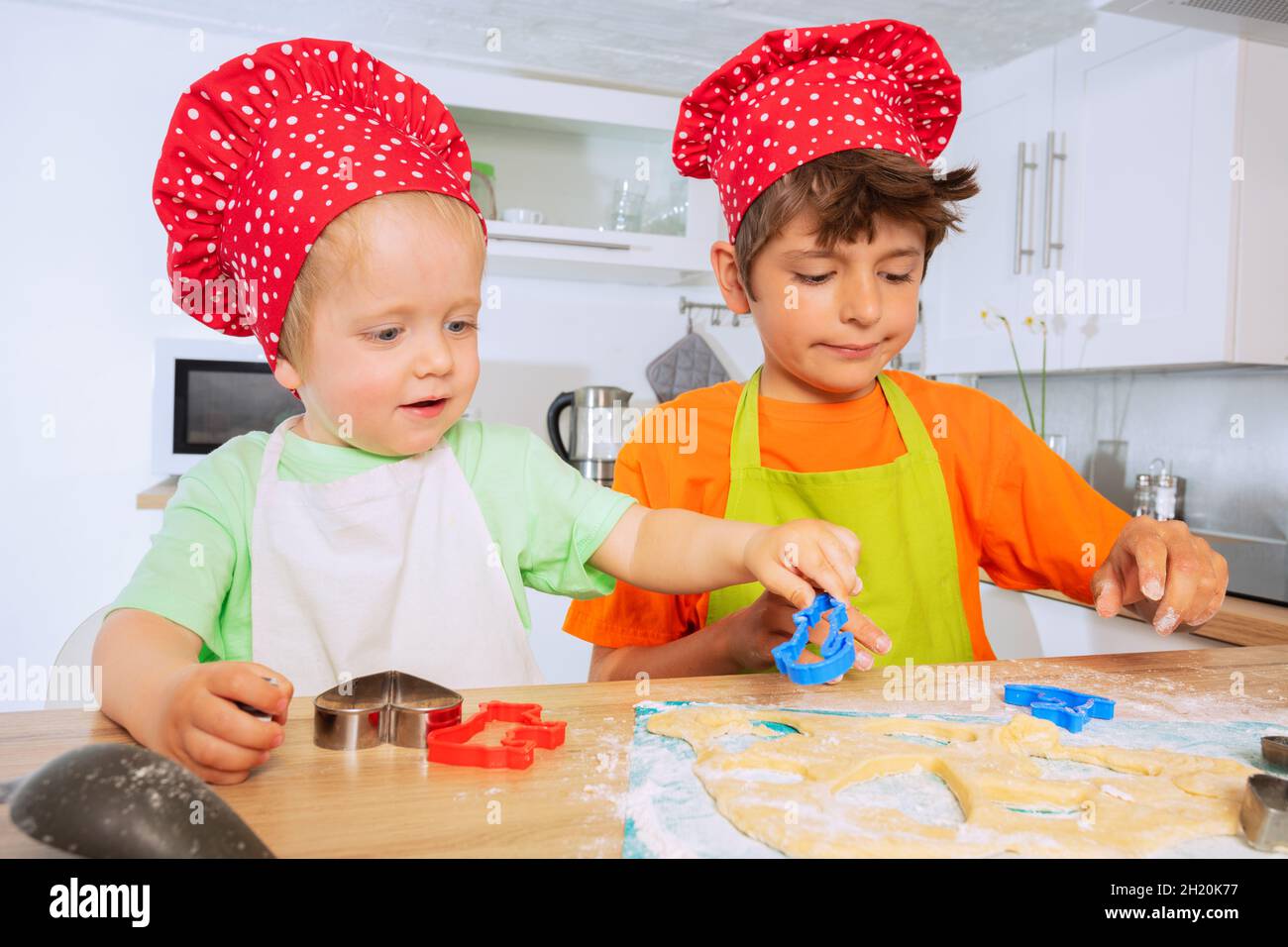 Children cutting dough out cookies in heart shapes Stock Photo - Alamy