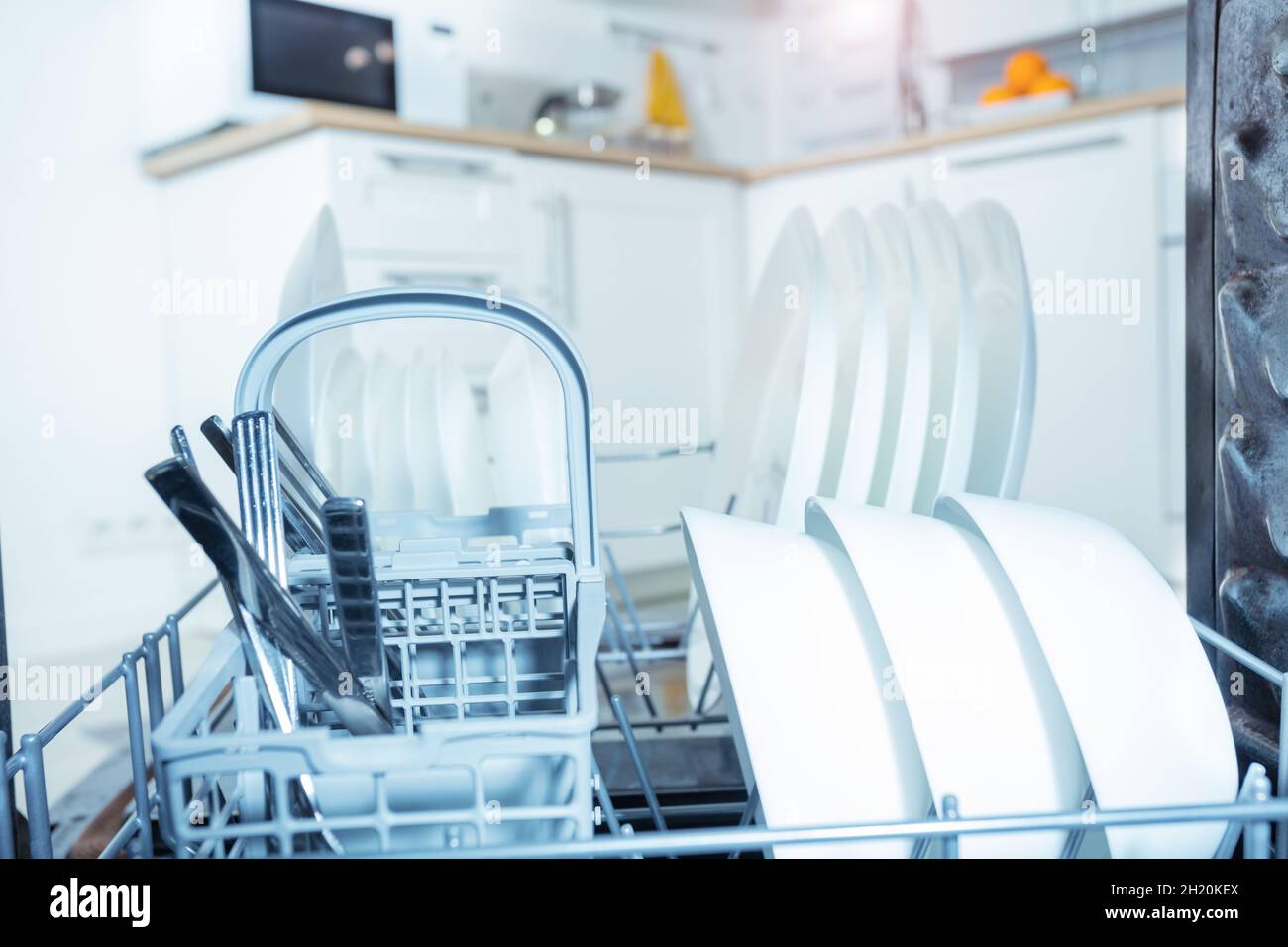 Plates dishes and silverware inside the dishwasher Stock Photo - Alamy