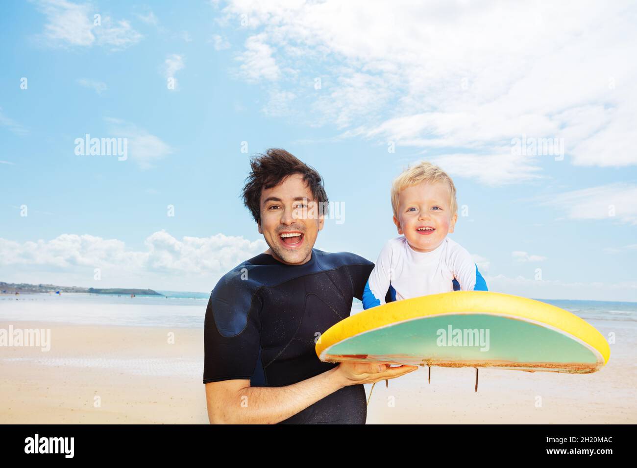 Fun with surfboard, father and son on the ocean Stock Photo - Alamy