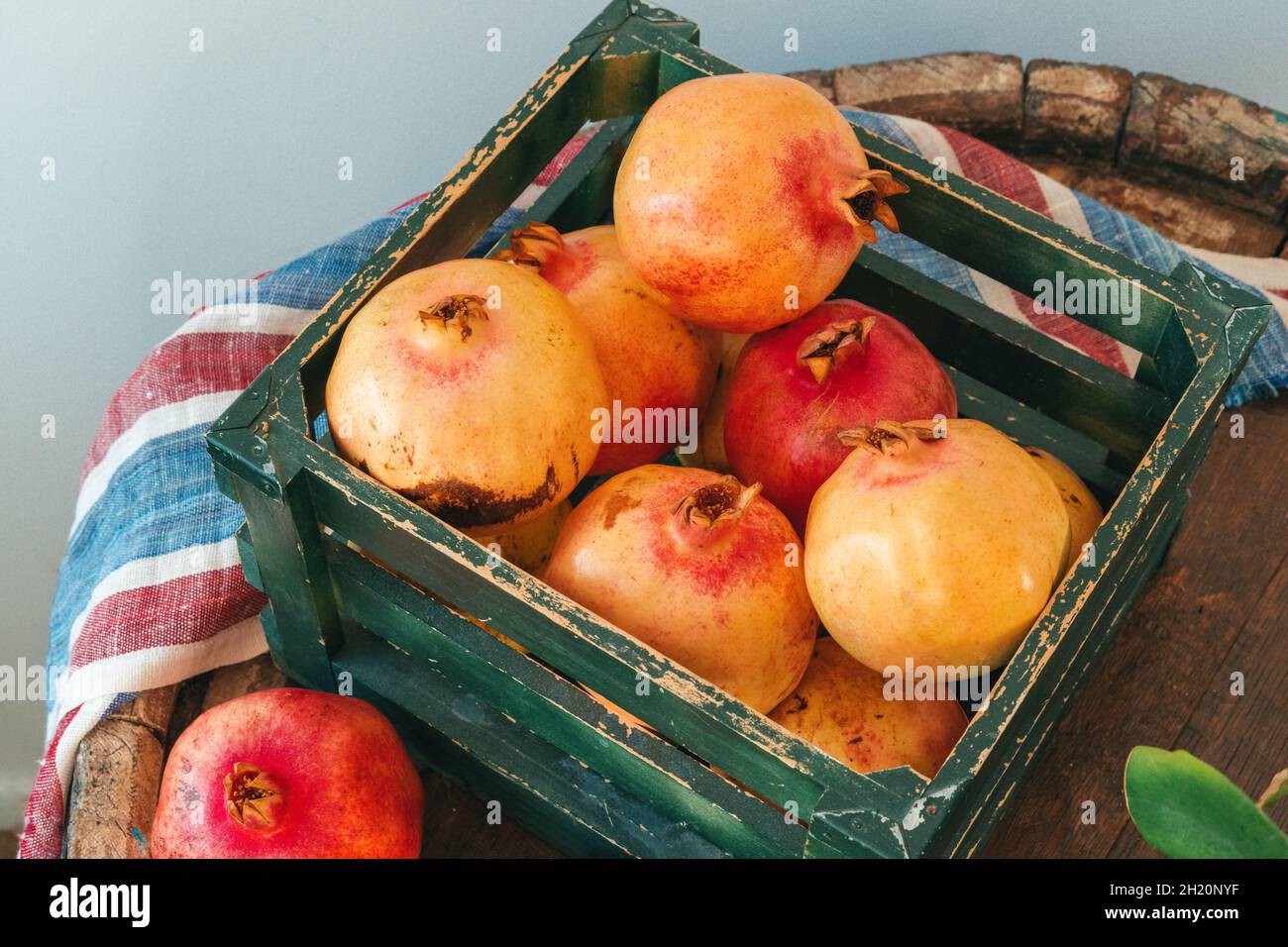 Fresh pomegranates in an old box on wooden background Stock Photo - Alamy