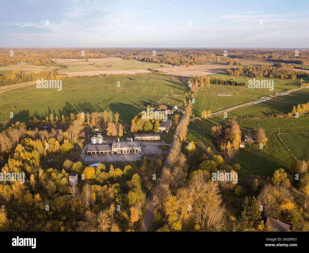 countryside roads in autumn colors with sunset light. drone image above ...