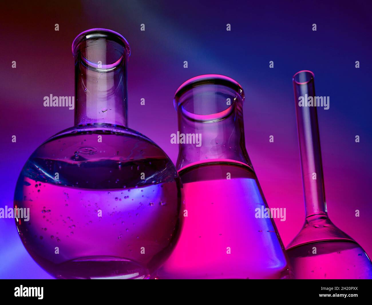 Laboratory glass tubes with chemicals on bright pink background Stock ...