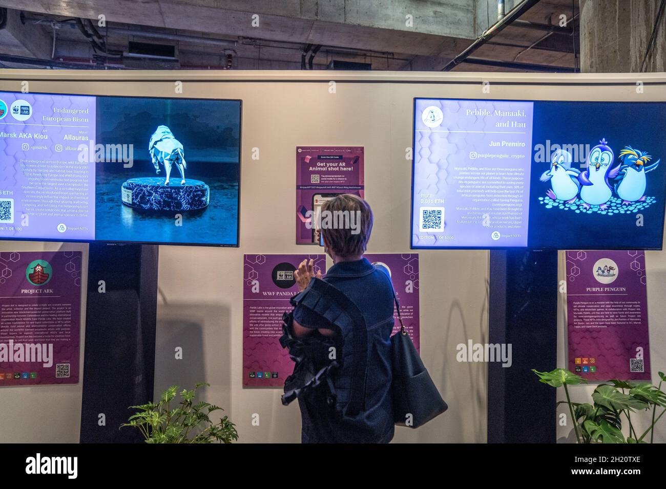 Hong Kong, China. 19th Oct, 2021. A woman looking at a poster, standing ...